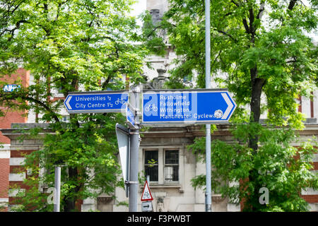 Sign showing "Universities, city centre, Rusholme, Fallowfield ...