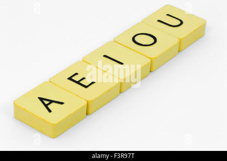 Yellow vowels cube with white background Stock Photo - Alamy