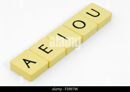 Yellow vowels cube with white background Stock Photo - Alamy