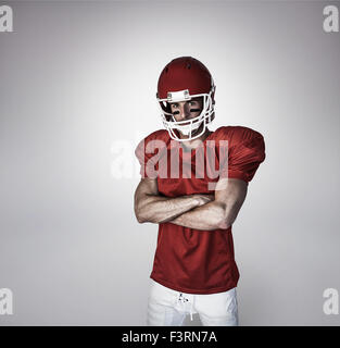 Thoughtful caucasian rugby player with arms crossed by circle and ...