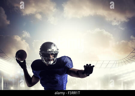 Composite image of sportsman throwing football Stock Photo - Alamy