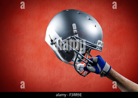 Composite image of cropped hand of sportsman holding helmet Stock Photo ...