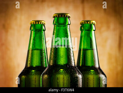 Wet beer bottles on rustic wooden table Stock Photo - Alamy
