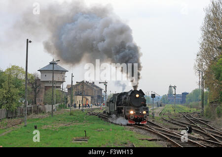 Passenger train starting from the station Stock Photo - Alamy