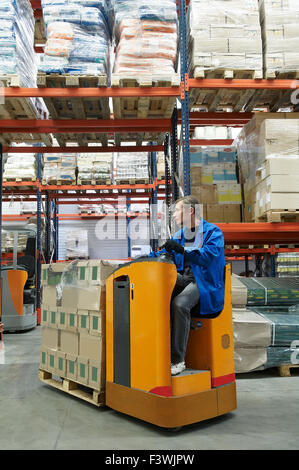 Electric Order Picker Truck in Distribution Warehouse Stock Photo - Alamy