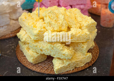 Yellow meringue cakes in pile on the wooden straw dish Stock Photo - Alamy
