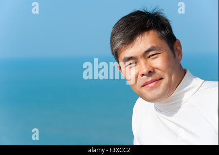 Handsome young Asian man with sweater, full length portrait isolated ...