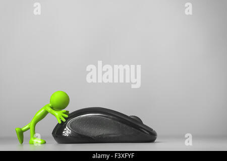 Green man pushing a computer mouse Stock Photo - Alamy