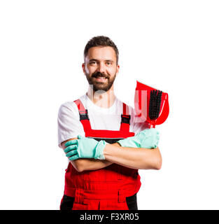 Young handsome man with a beard is holding red shopping bags posing on ...