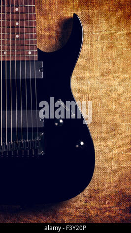 black electric eight-string guitar, painted metal background Stock ...