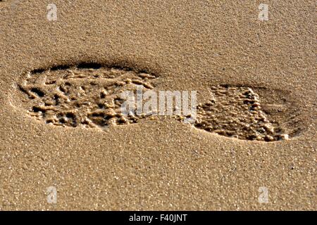 Trainer footprint in sand Stock Photo - Alamy