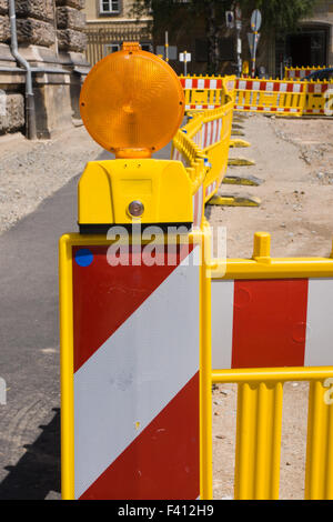 Red and white striped warning poles for the presence of buried gas pipe ...