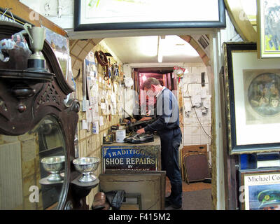 An old fashioned Cobbler's Shoe Repair shop in a village High Street ...