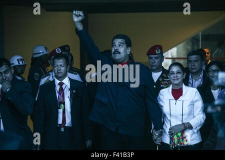 Venezuelan President Nicolas Maduro salutes supporters on his ...