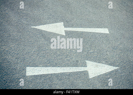 Arrows to the Right and Left on an Asphalt Road - A Concept for ...