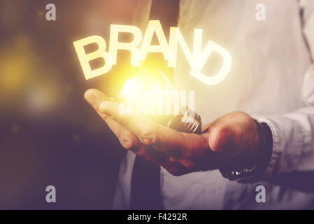 Businessman holding a light bulb Stock Photo - Alamy
