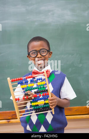 Smiling pupil holding abacus Stock Photo - Alamy
