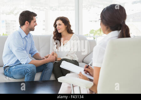 Reconciled couple smiling at each other Stock Photo - Alamy
