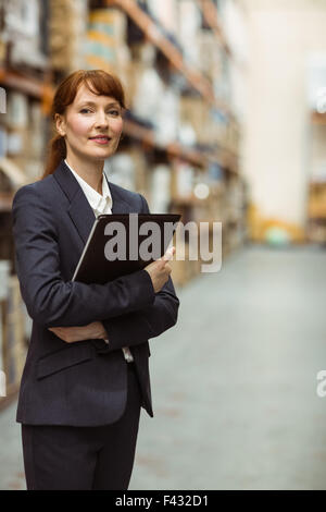 female warehouse manager with file folder in warehouse Stock Photo - Alamy