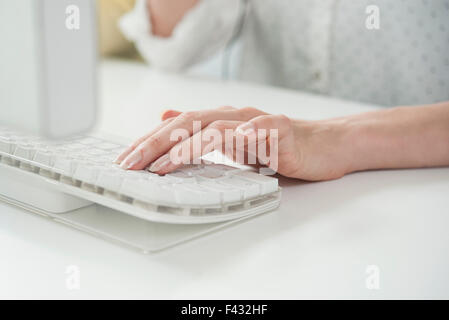 Cropped image of business workers typing and working on laptop computer ...