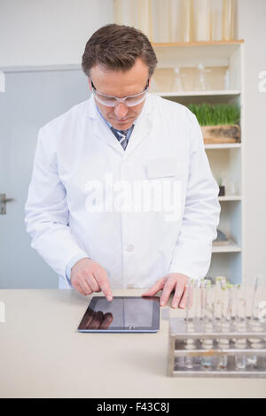 Serious scientist using tablet pc Stock Photo - Alamy