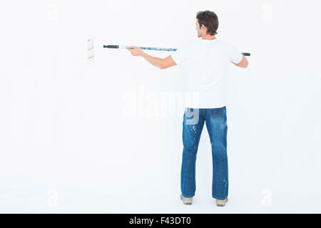 Man using paint roller on white background Stock Photo - Alamy