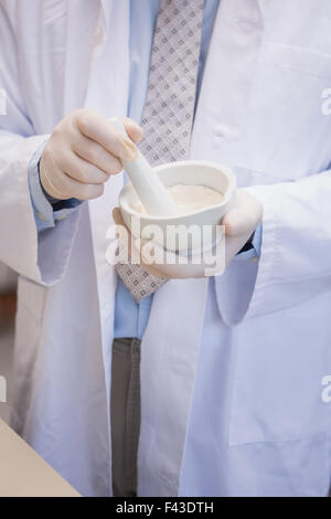 Scientist grinding powder with mortar Stock Photo - Alamy
