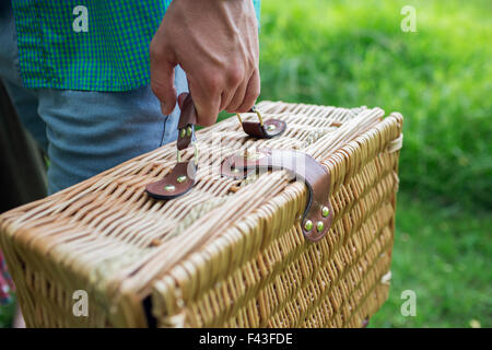 Hand holding a wicker basket on a canvas background Stock Photo - Alamy