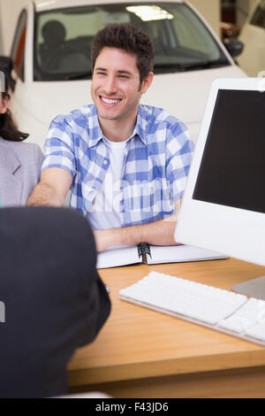 Smiling customer shaking a salesman hand Stock Photo - Alamy