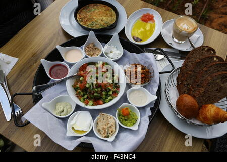 Traditional Israeli Breakfast with omelet, cheeses, salads, a fresh ...