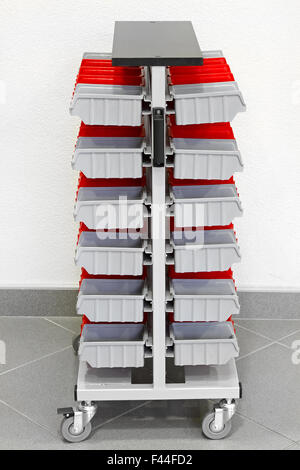 Trolley with plastic shelves for parts storage Stock Photo - Alamy