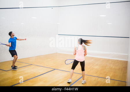 Competitive couple playing squash together Stock Photo - Alamy