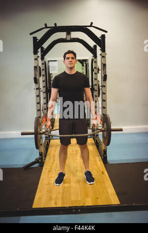 Man in the gym lifting heavy weights. Lifting heavy weights ...