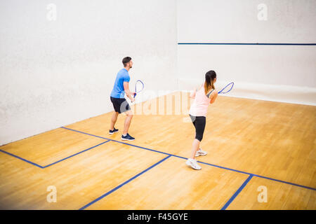 Couple playing a game of squash Stock Photo - Alamy
