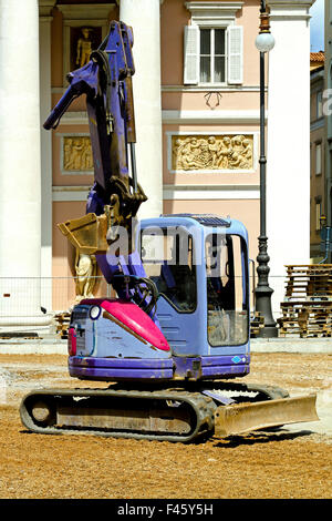 Small purple digger machinery for street construction Stock Photo - Alamy