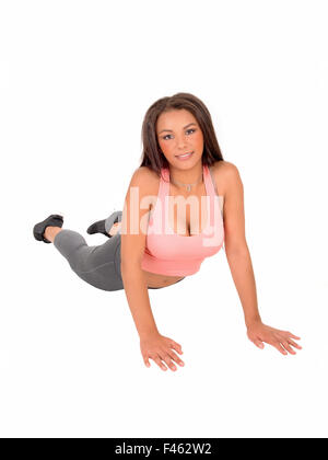 Beautiful slim brunette doing some push ups a the gym Stock Photo - Alamy