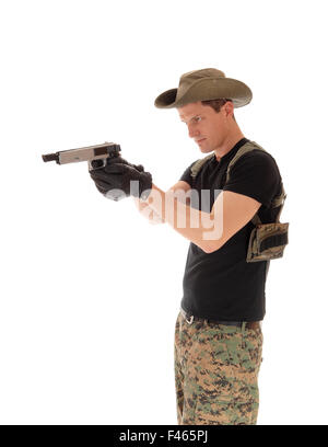portrait of young military man pointing gun, wearing green army wear ...