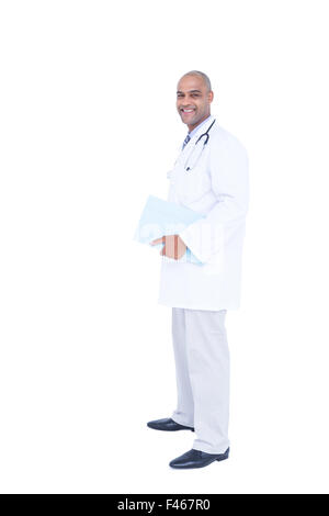 Standing doctor in white tunic writing notes Stock Photo - Alamy
