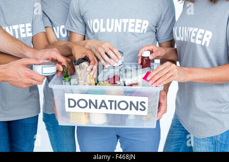 Volunteers friends separating donation stuffs Stock Photo - Alamy