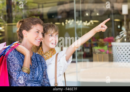 Beautiful women pointing in the distance Stock Photo - Alamy