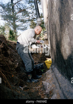 A man building a wall, Uppsala, Sweden Stock Photo - Alamy