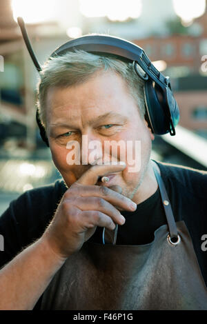A smoking engine fitter, Sweden Stock Photo - Alamy