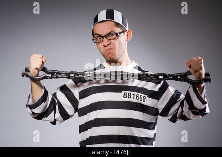 Funny prisoner in chains isolated on gray Stock Photo - Alamy