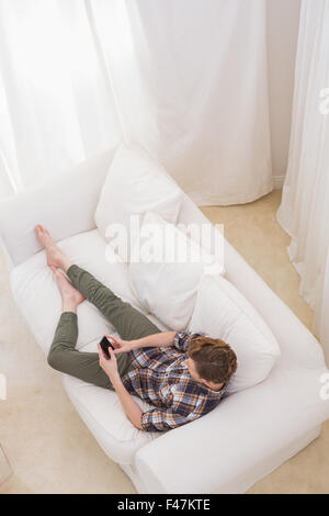 Young handsome man showing smartphone screen pointing and showing with ...