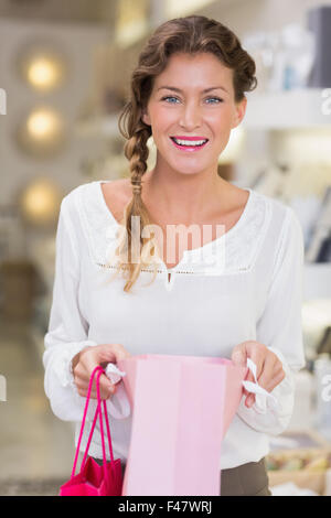 Beautiful caucasian woman holding shopping bags and 500 norwegian krone ...