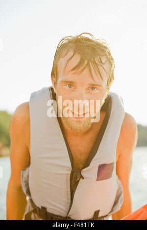 Man wearing life jacket and wet suit racing jet ski on river Stock ...