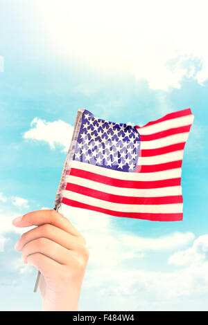 Composite image of hand waving american flag Stock Photo - Alamy