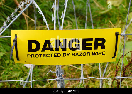 Danger Razor Wire warning sign on top of a security fence in the UK ...