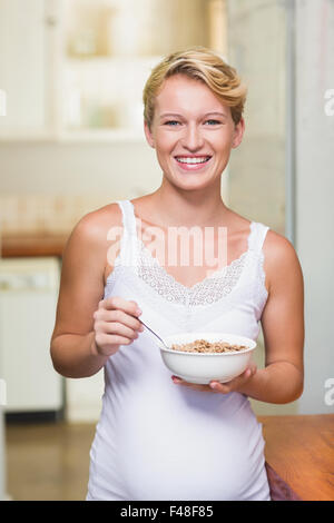 Beautiful young pregnant woman with bowl of fresh vegetable salad in ...