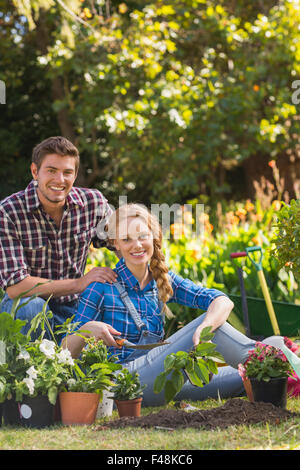 Happy young couple gardening together Stock Photo - Alamy